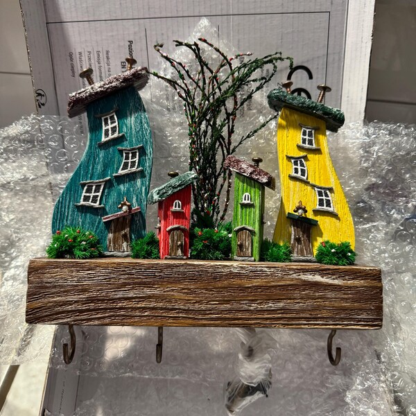 Wooden Key Holder With Colorful Houses and Green Plants on a Wild ...