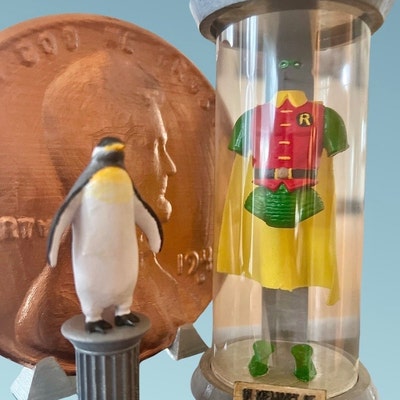 Batcave Trophy Room With Robin Memorial, Giant Penny, Penguin, and ...