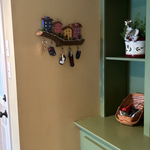 Wooden Key Holder With Colorful Houses and Green Plants on a Wild ...