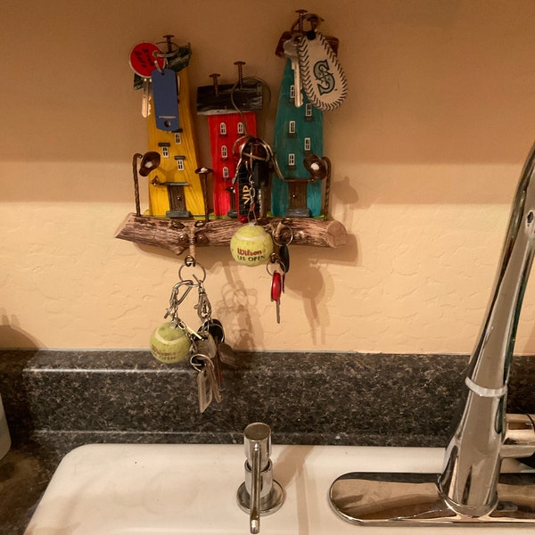 Wooden Key Holder With Colorful Houses and Green Plants on a Wild ...