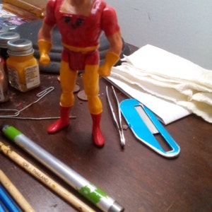 Batcave Trophy Room With Robin Memorial, Giant Penny, Penguin, and ...